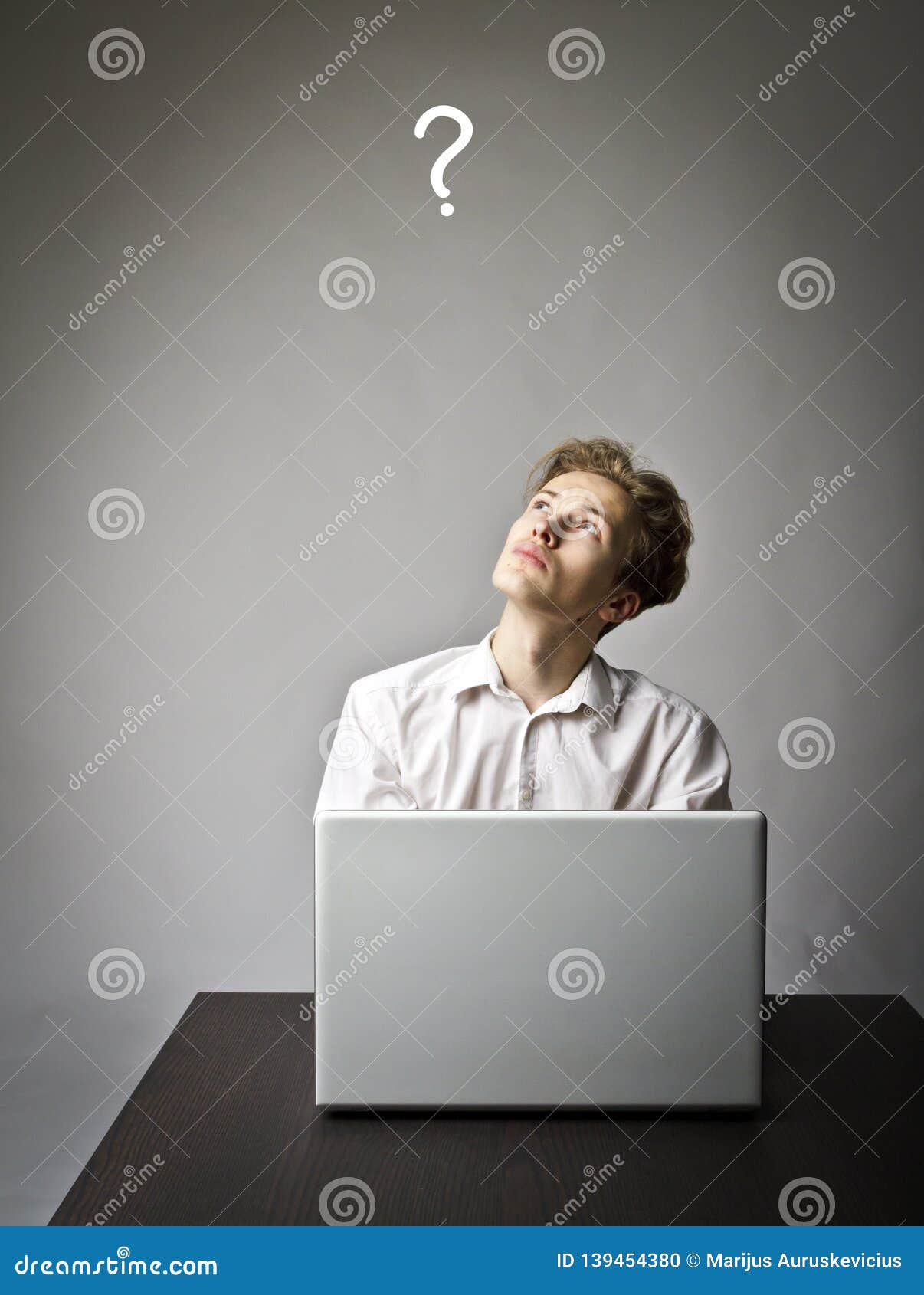 Young Man with Laptop. Question and Ignorance Concept Stock Photo ...