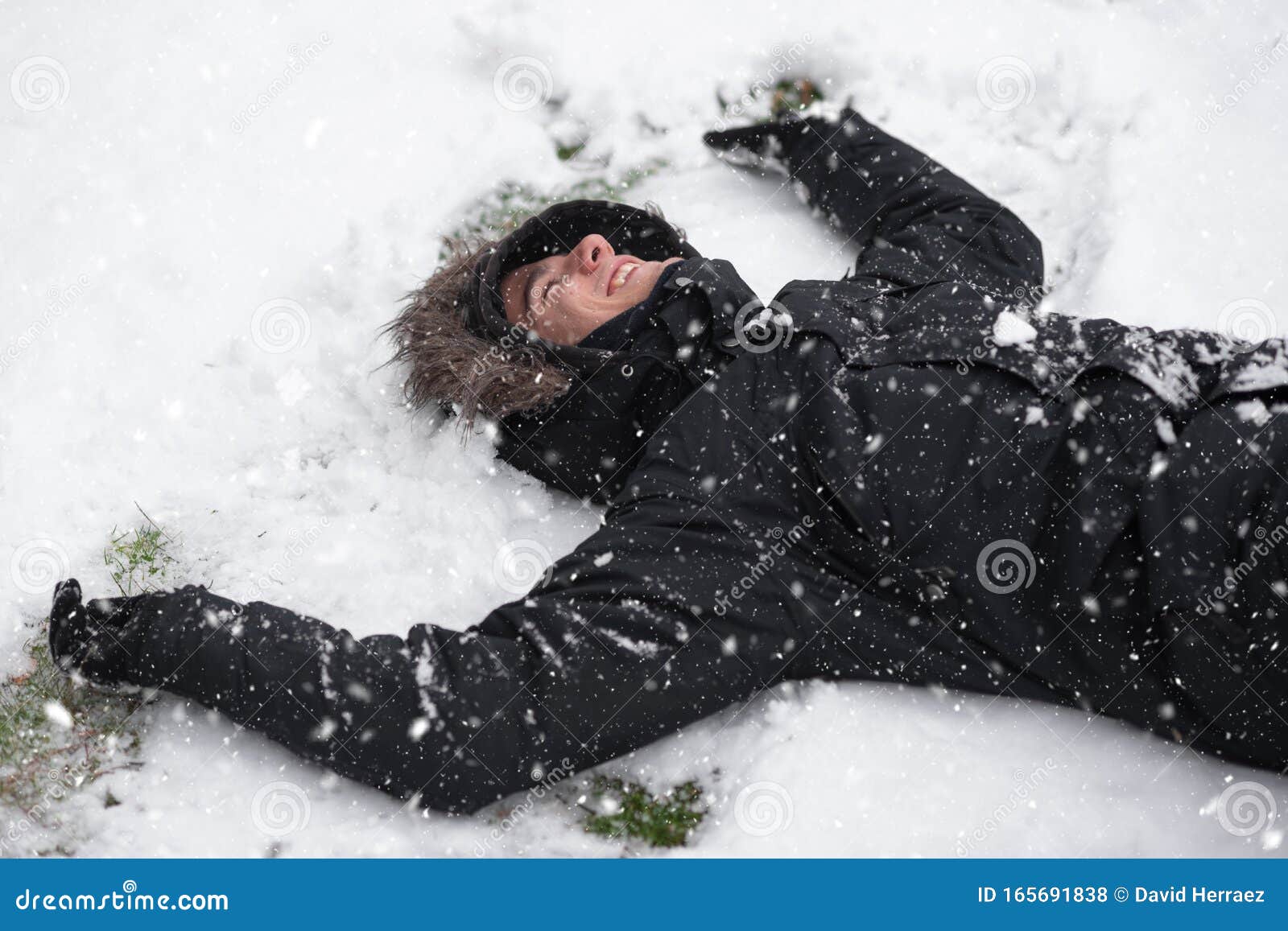 Young Man Laughing, with Happy Expression, Snow Covered, Lying on the ...