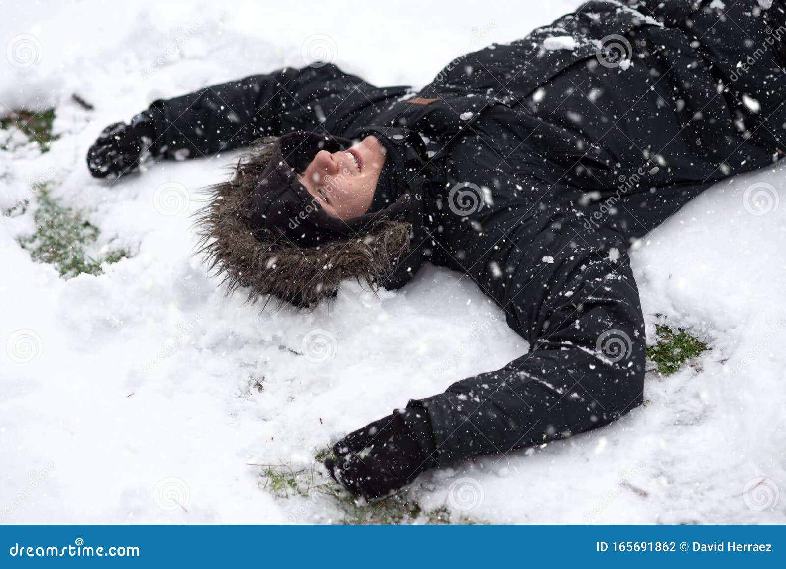 Young Man Laughing, with Happy Expression, Snow Covered, Lying on the ...
