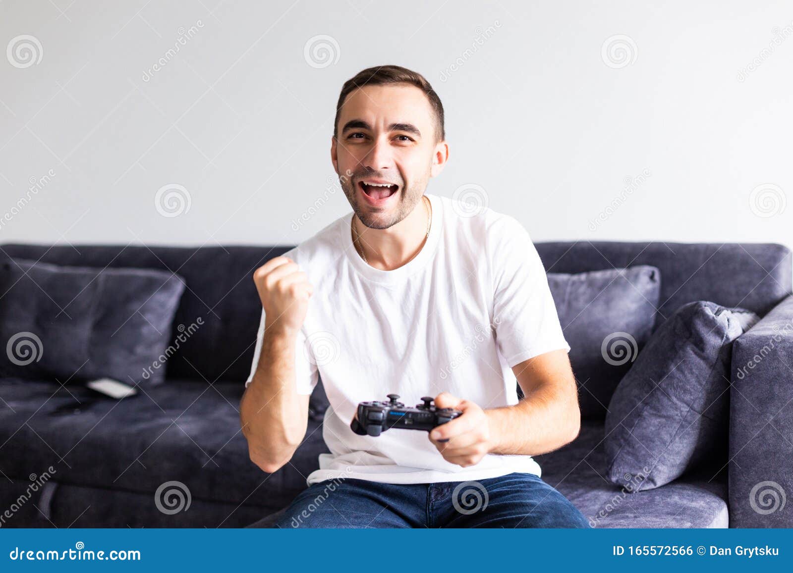 Young Happy Man Laughing and Playing Video Games on Weekend Stock Photo ...