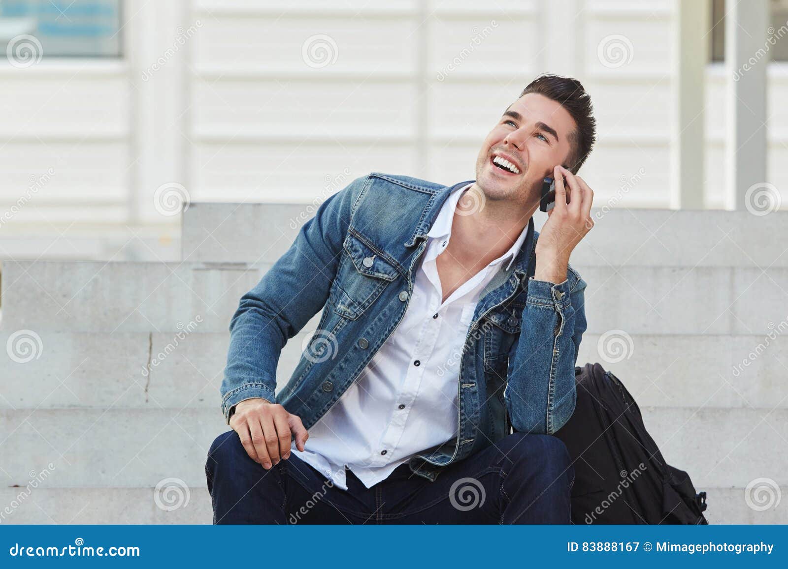 Young Man Laughing and Talking on Mobile Phone Stock Image - Image of ...