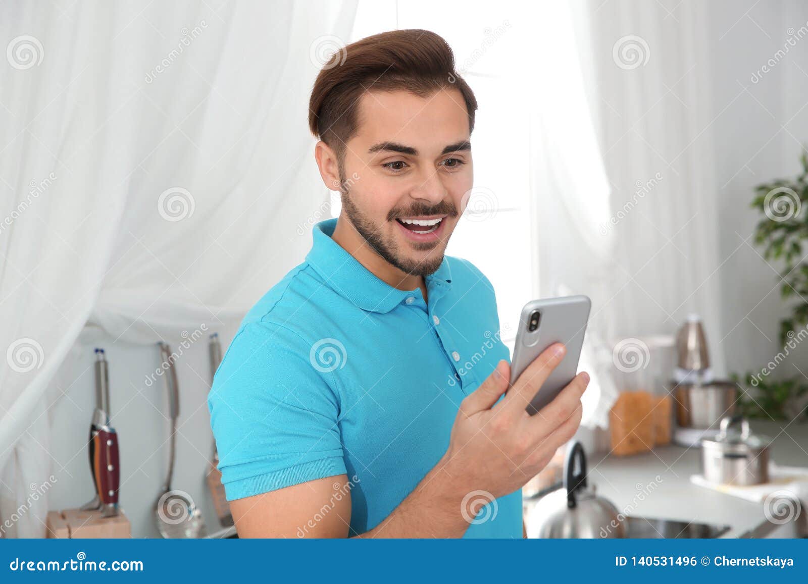 Young Man Laughing while Using Smartphone Stock Photo - Image of face ...