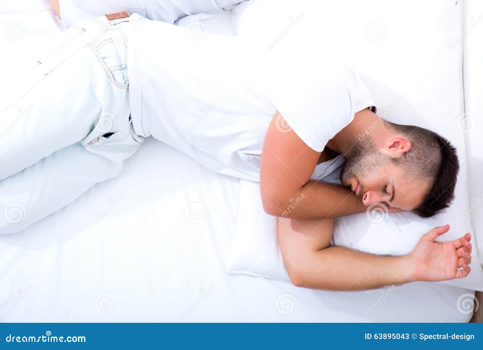 Young man laying in bed stock image. Image of exhausted - 63895043