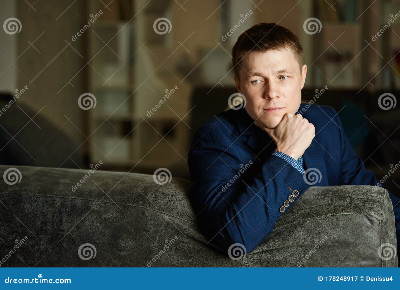 The Young Man Leaned Thoughtfully on the Back of the Sofa, Looking Down ...