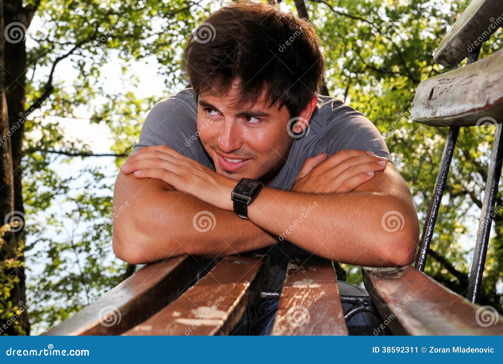 Young Man Leaning on a Bench in the Park Stock Image - Image of adult ...