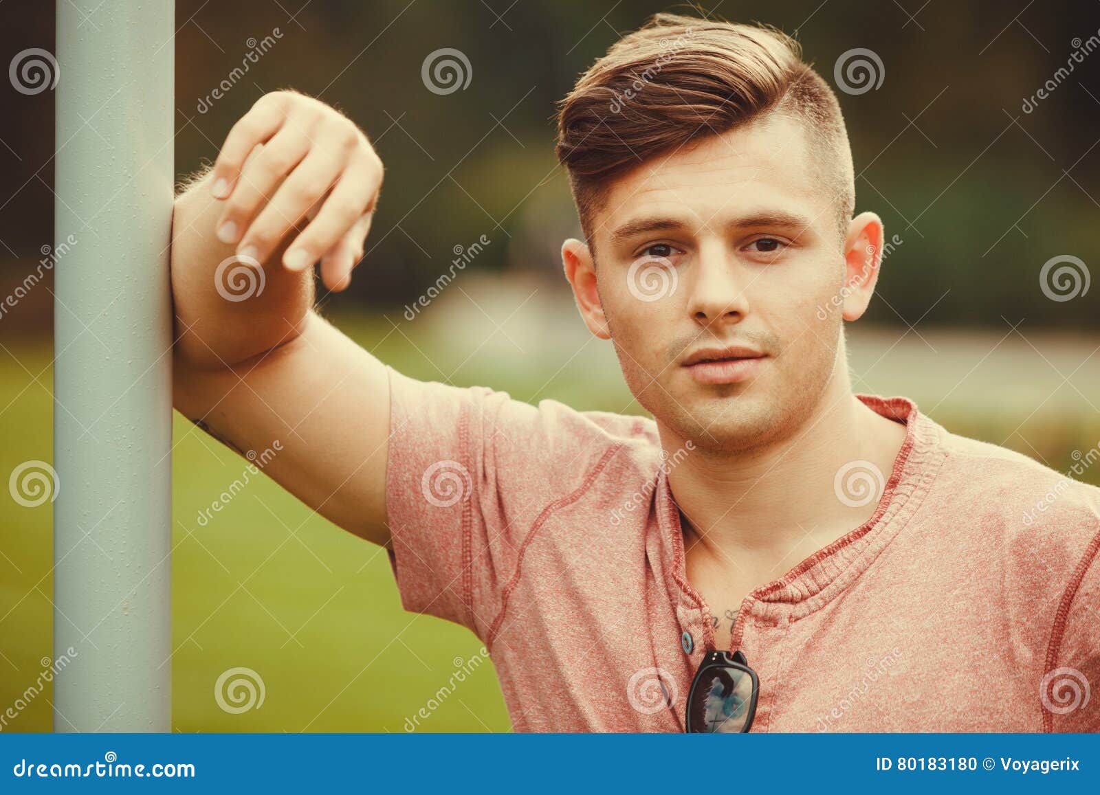 Young man leaning on pole. stock photo. Image of young - 80183180