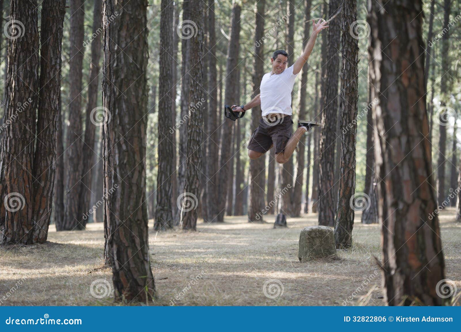 A Young Man Leaps through the Trees Stock Photo - Image of bright, lead ...