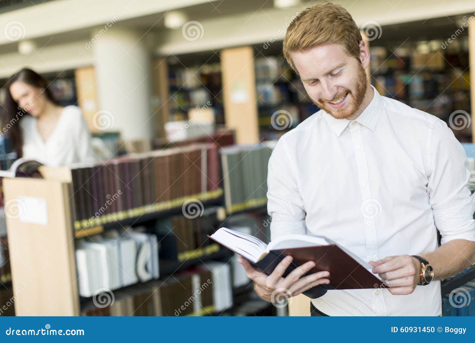 Young man in the library stock photo. Image of reader - 60931450
