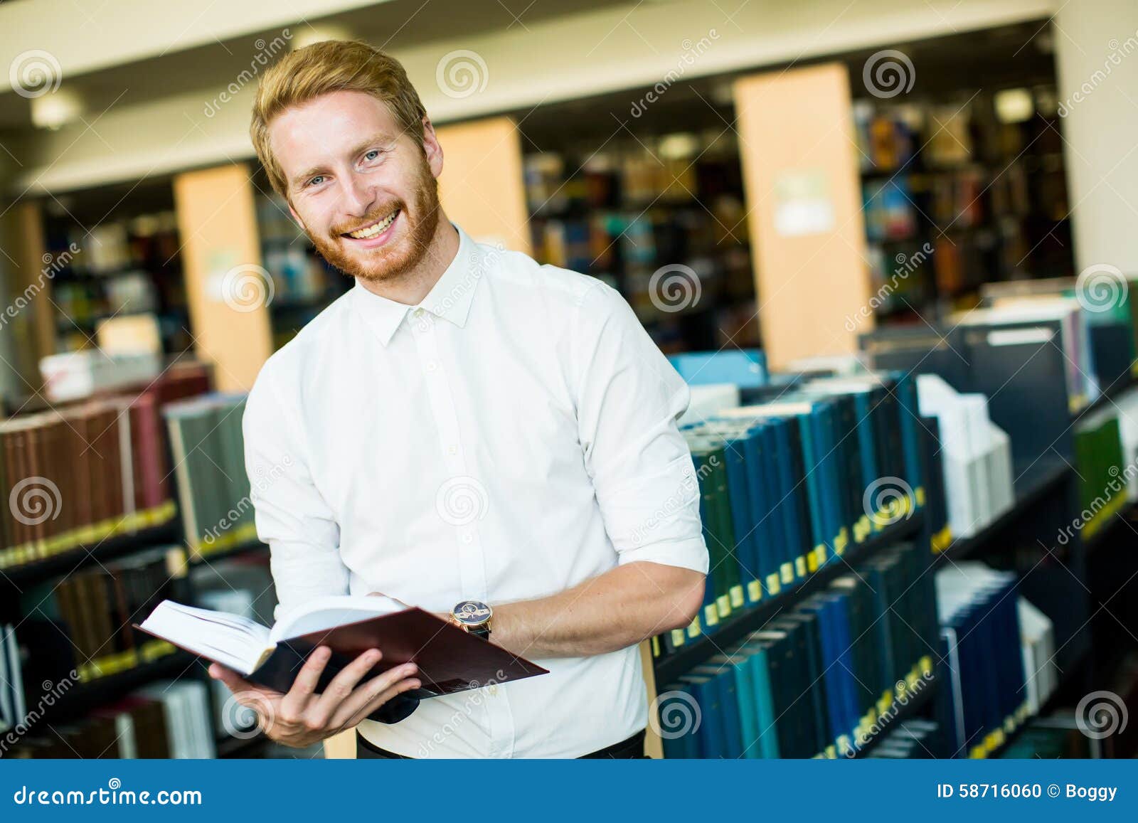 Young man in the library stock photo. Image of reader - 58716060