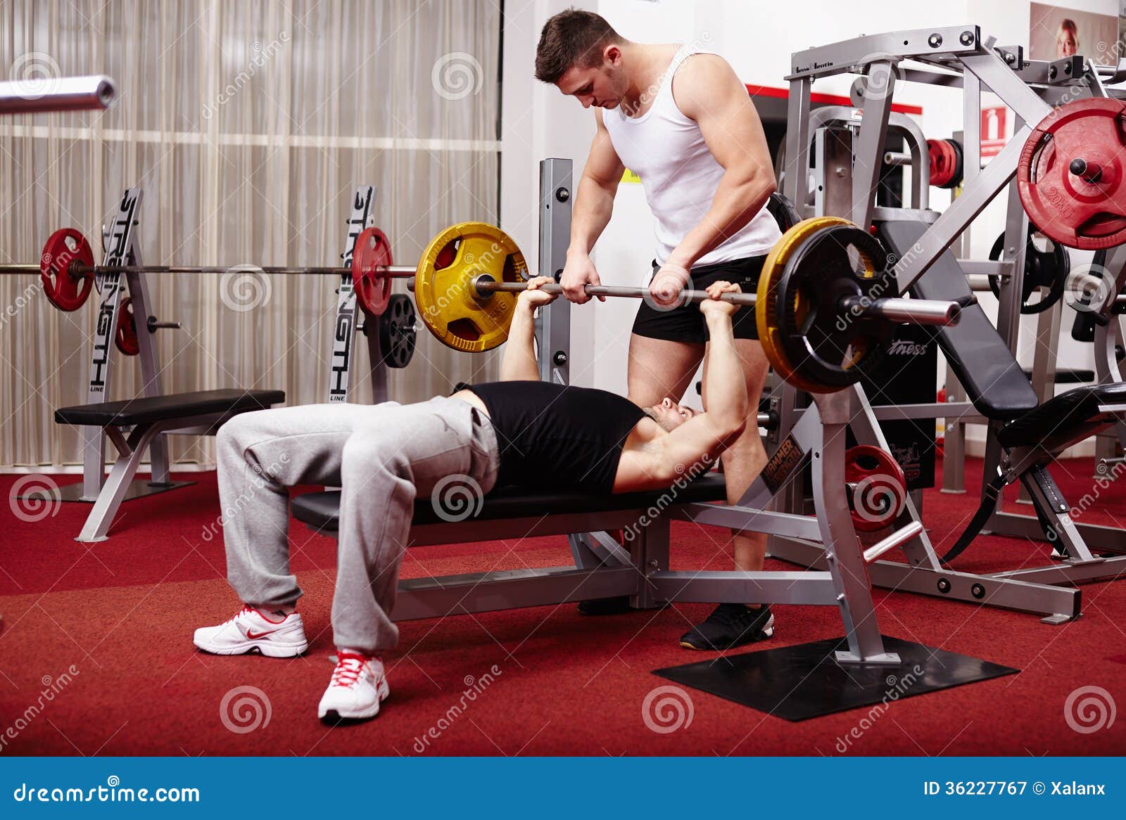 Young Man Lifting the Barbell with Help Stock Image - Image of couple ...