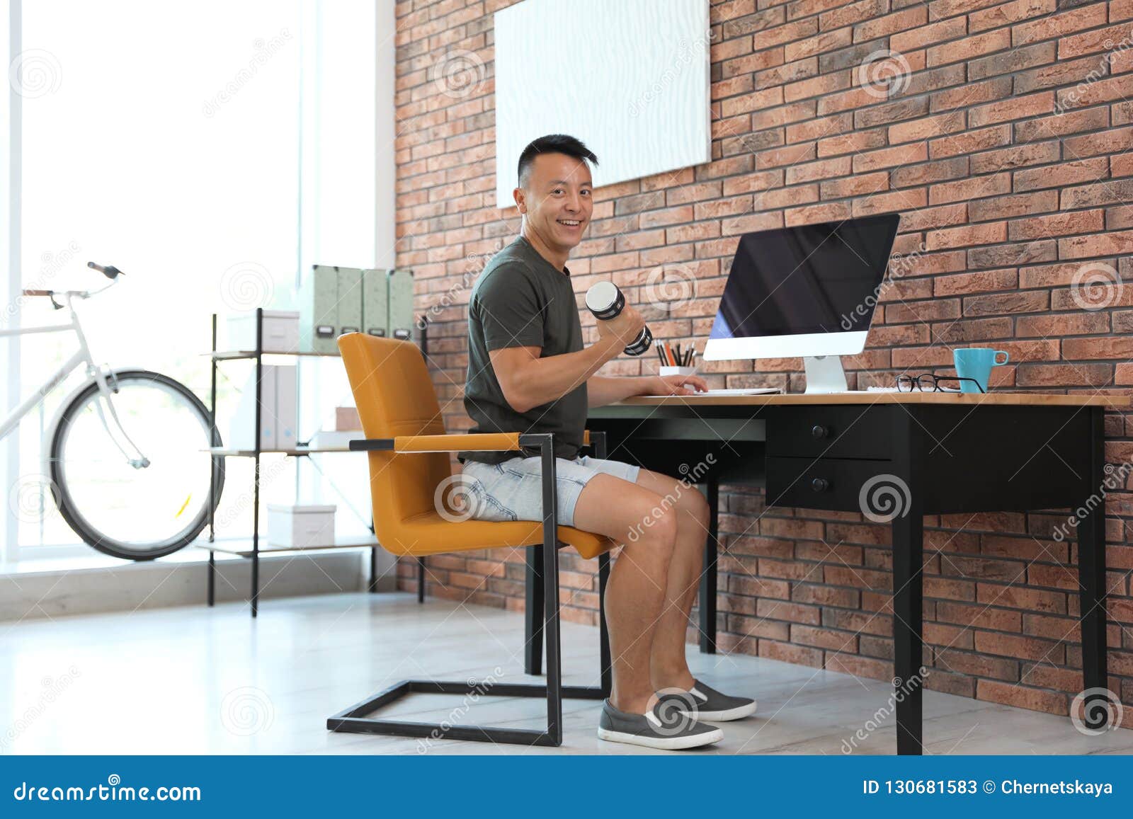 Young Man Lifting Weights and Using Computer Stock Image - Image of ...