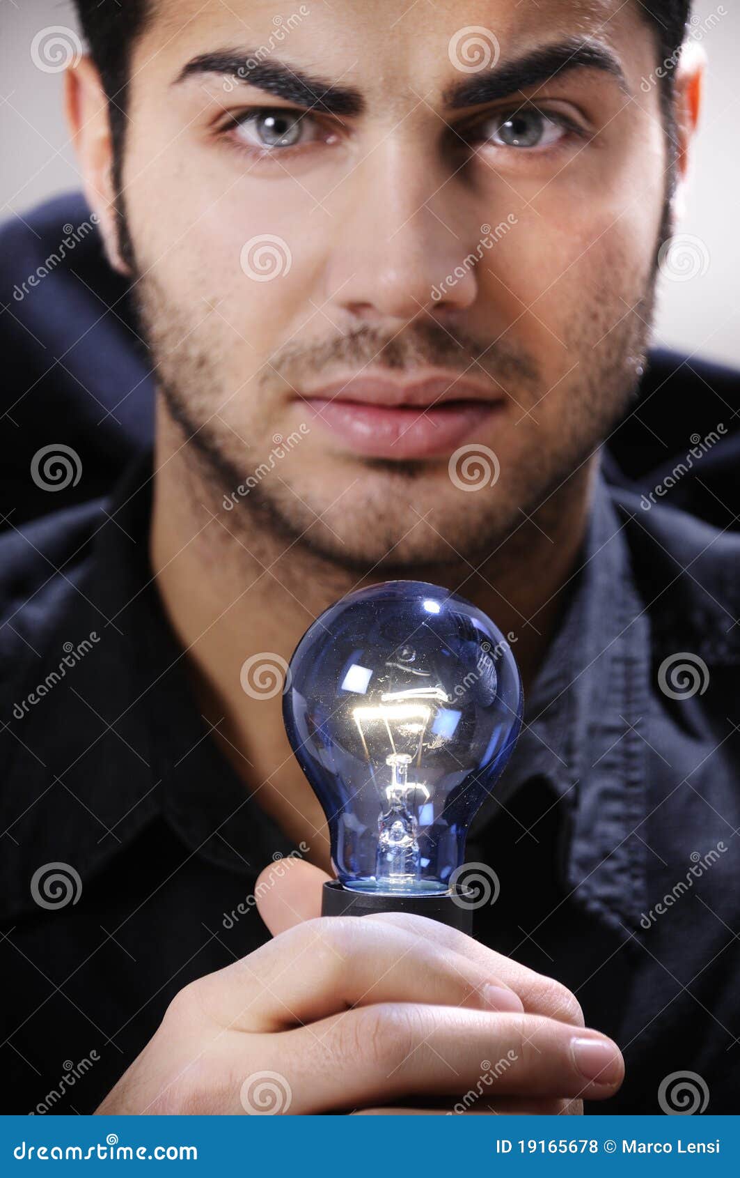 Young Man with Light Bulb in His Hands Stock Photo - Image of consumers ...