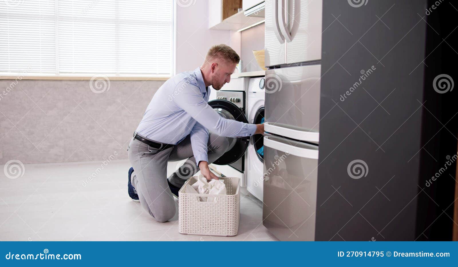 Young Man Loading Clothes into Washing Machine Stock Image - Image of ...