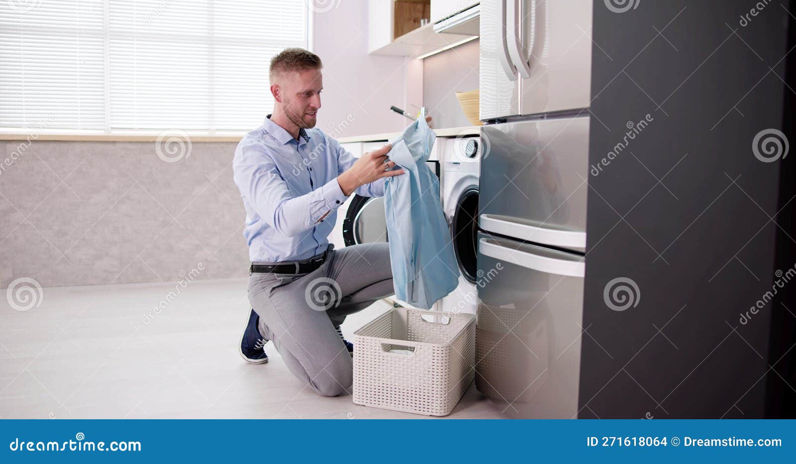 Young Man Loading Clothes into Washing Machine Stock Photo - Image of ...
