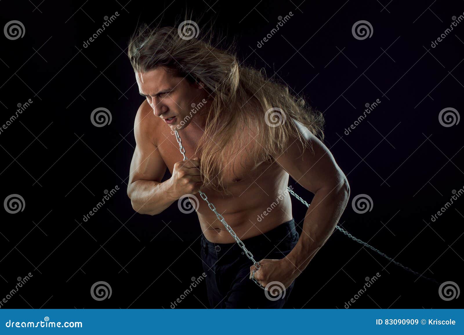 Young Man with Long Hair Dragging Something Behind Him. Strong. Stock ...