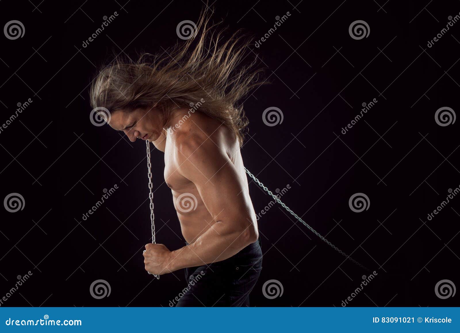Young Man with Long Hair Dragging Something Behind Him. Strong. Stock ...