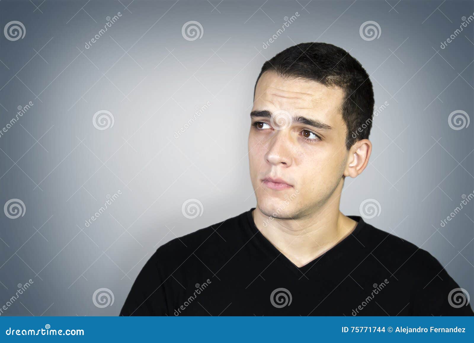 Young Man Looking Aside Over Neutral Blue Background Stock Photo ...