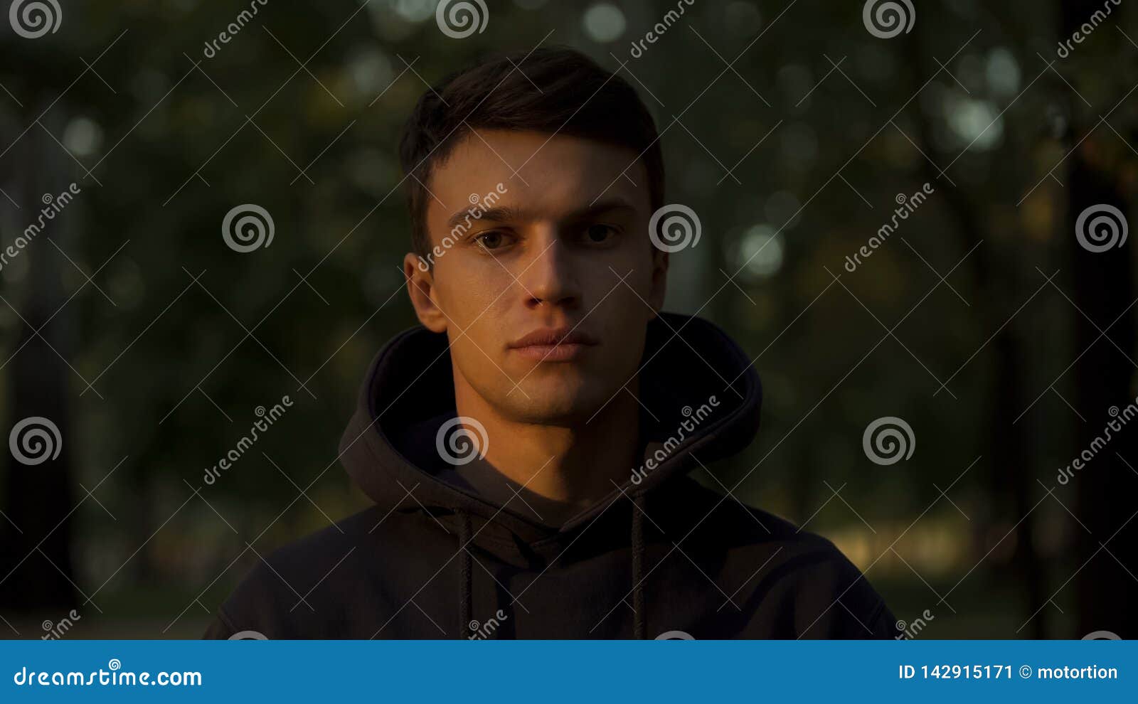 Young Man Looking at Camera, Half Shadowed Face, Good and Evil Fight ...