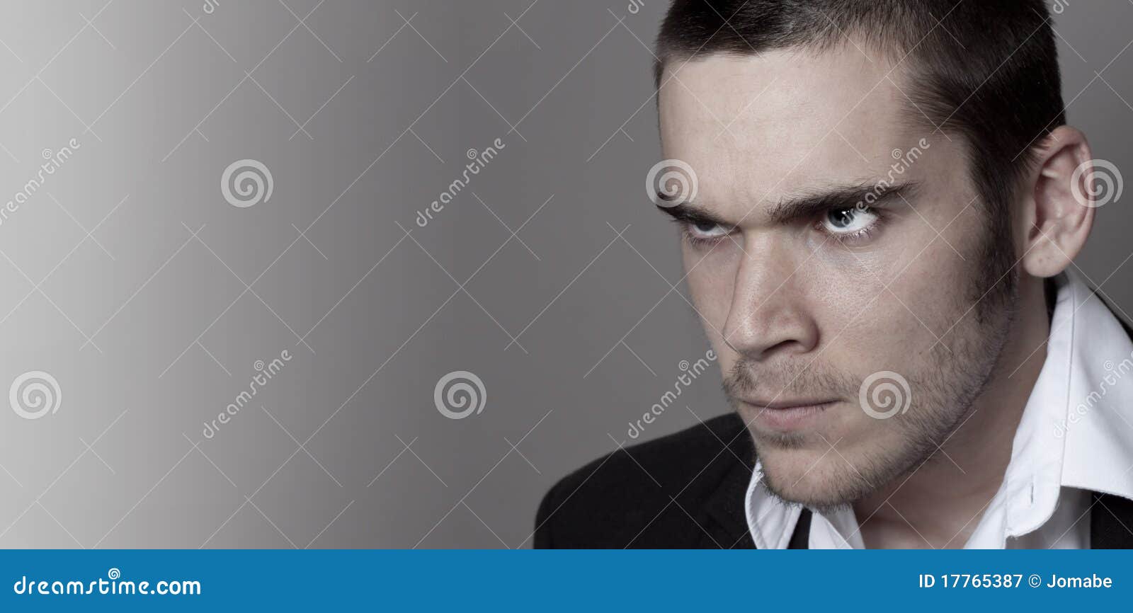 Young man looking defiant. stock image. Image of blue - 17765387