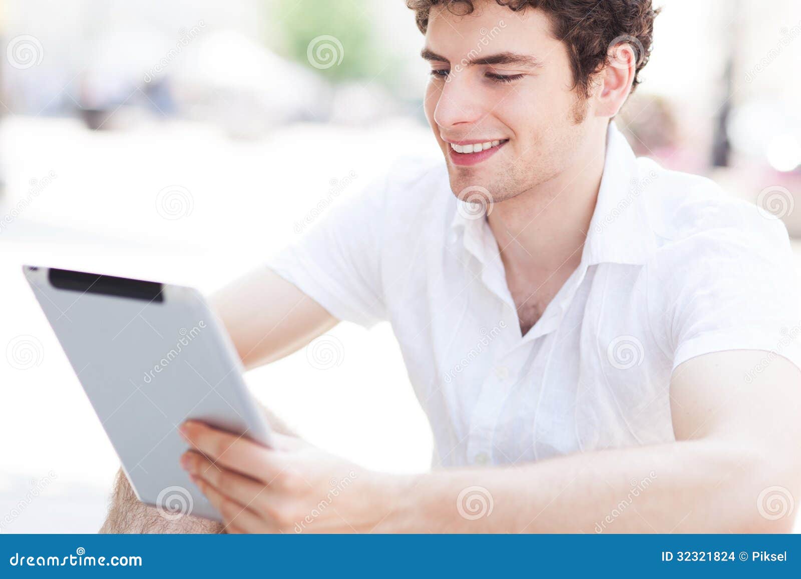 Young Man Looking at Digital Tablet Stock Photo - Image of adult ...
