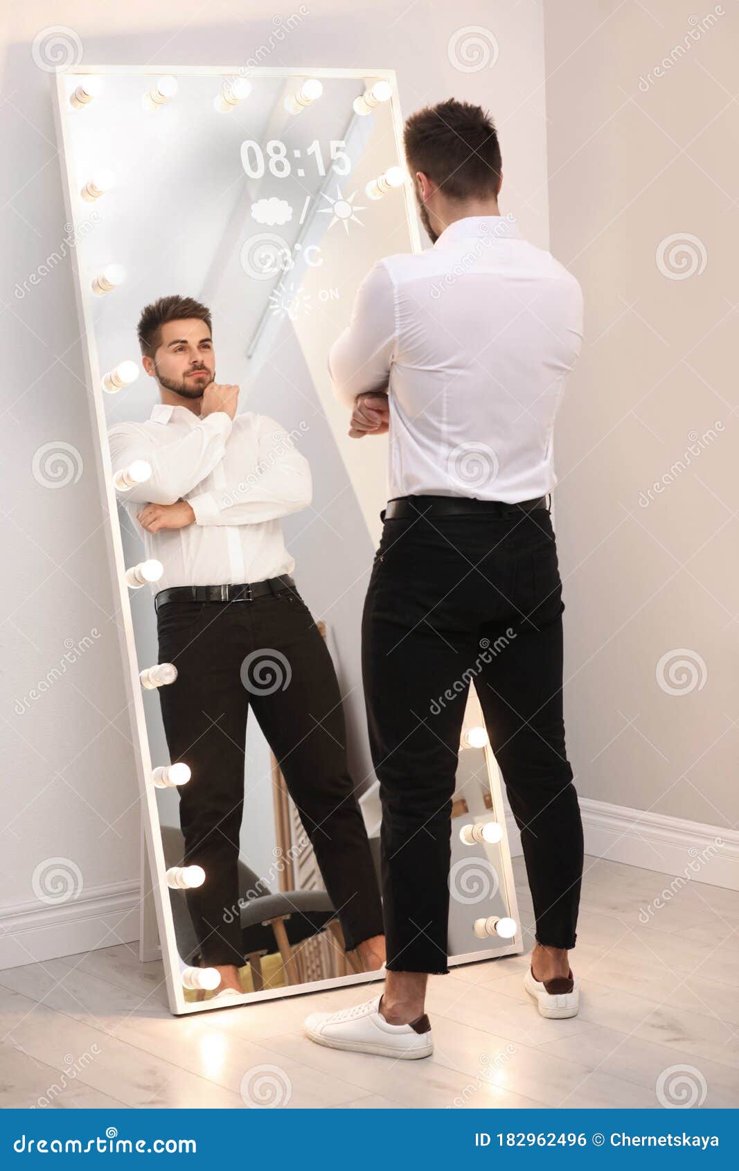 Young Man Looking at Himself in Smart Mirror Stock Photo - Image of ...