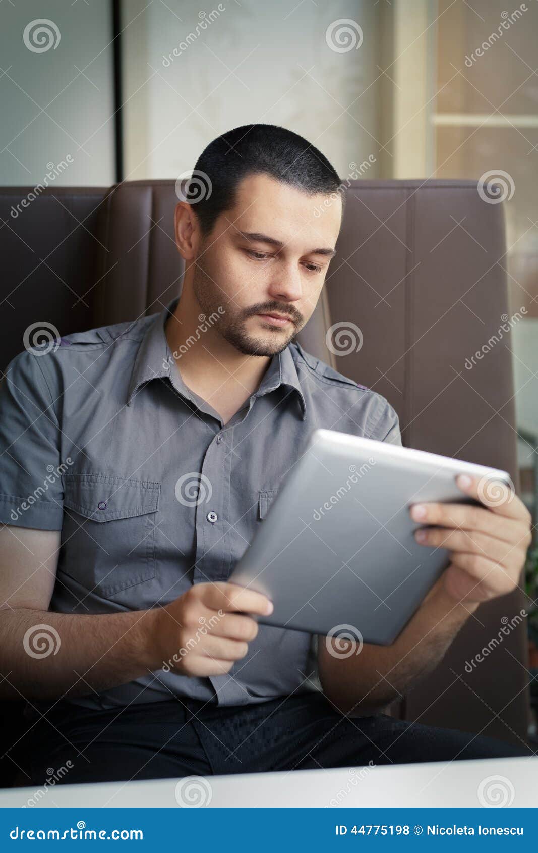 Young Man Looking at His Tablet Stock Photo - Image of businessman ...