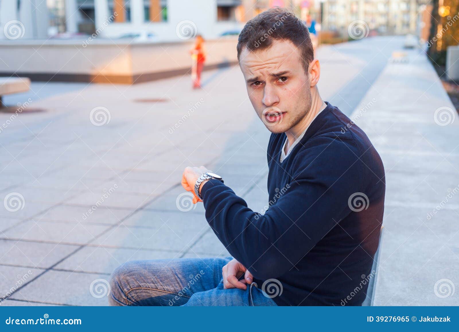 Young Man is Looking at His Watch Checking the Time. Stock Image ...