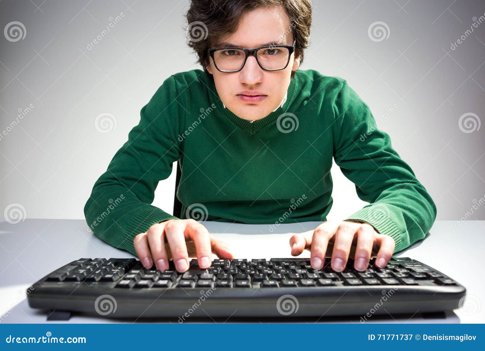 Young man looking intently stock image. Image of computer - 71771737