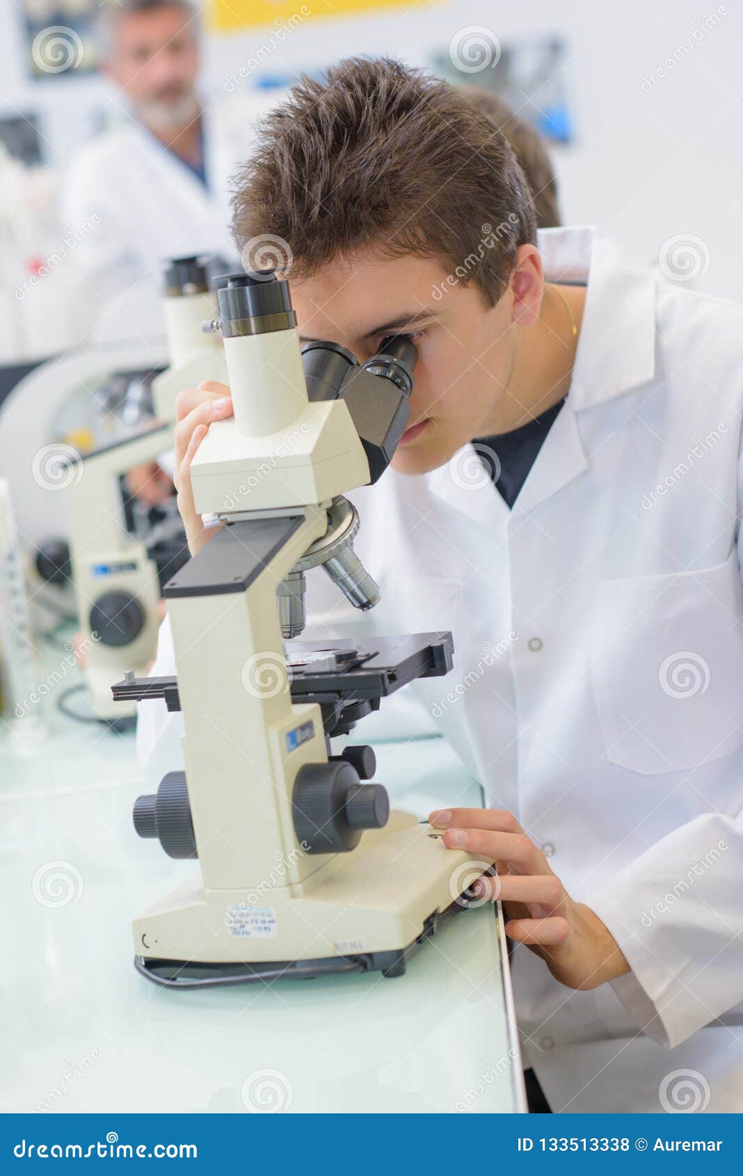 Young Man Looking in Microscope Stock Photo - Image of discover ...