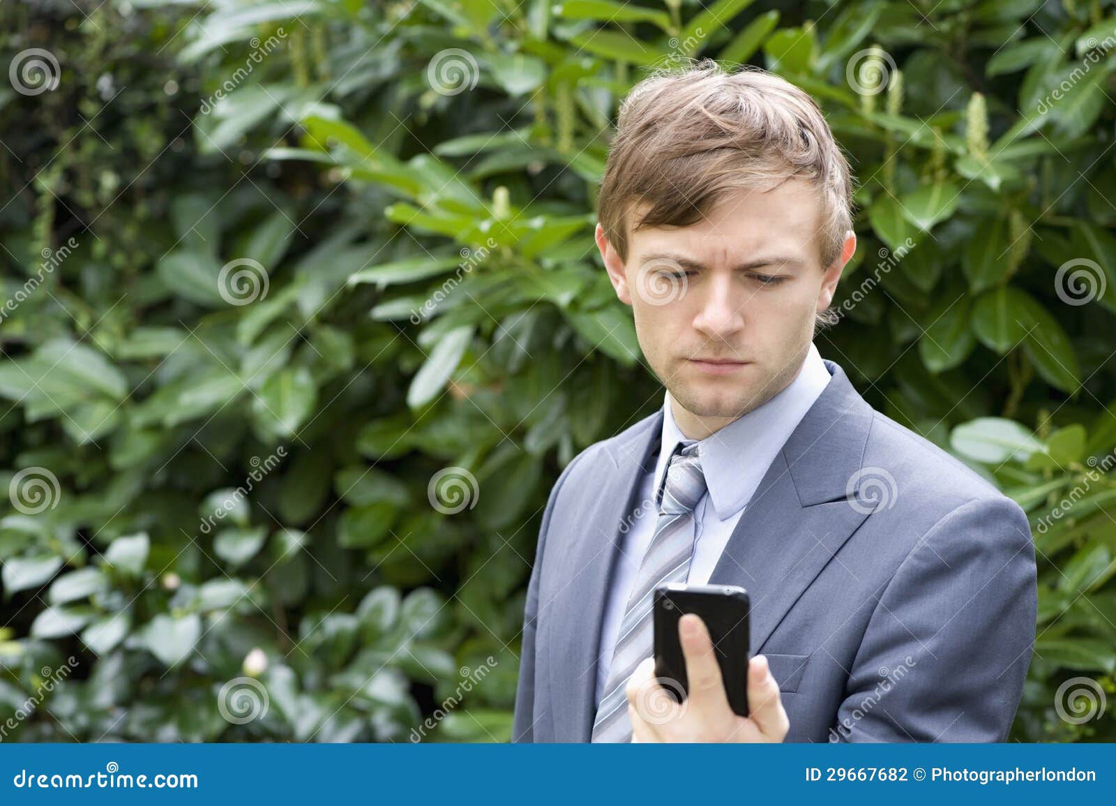 Young Man Looking at Mobile Phone Stock Photo - Image of view, identity ...