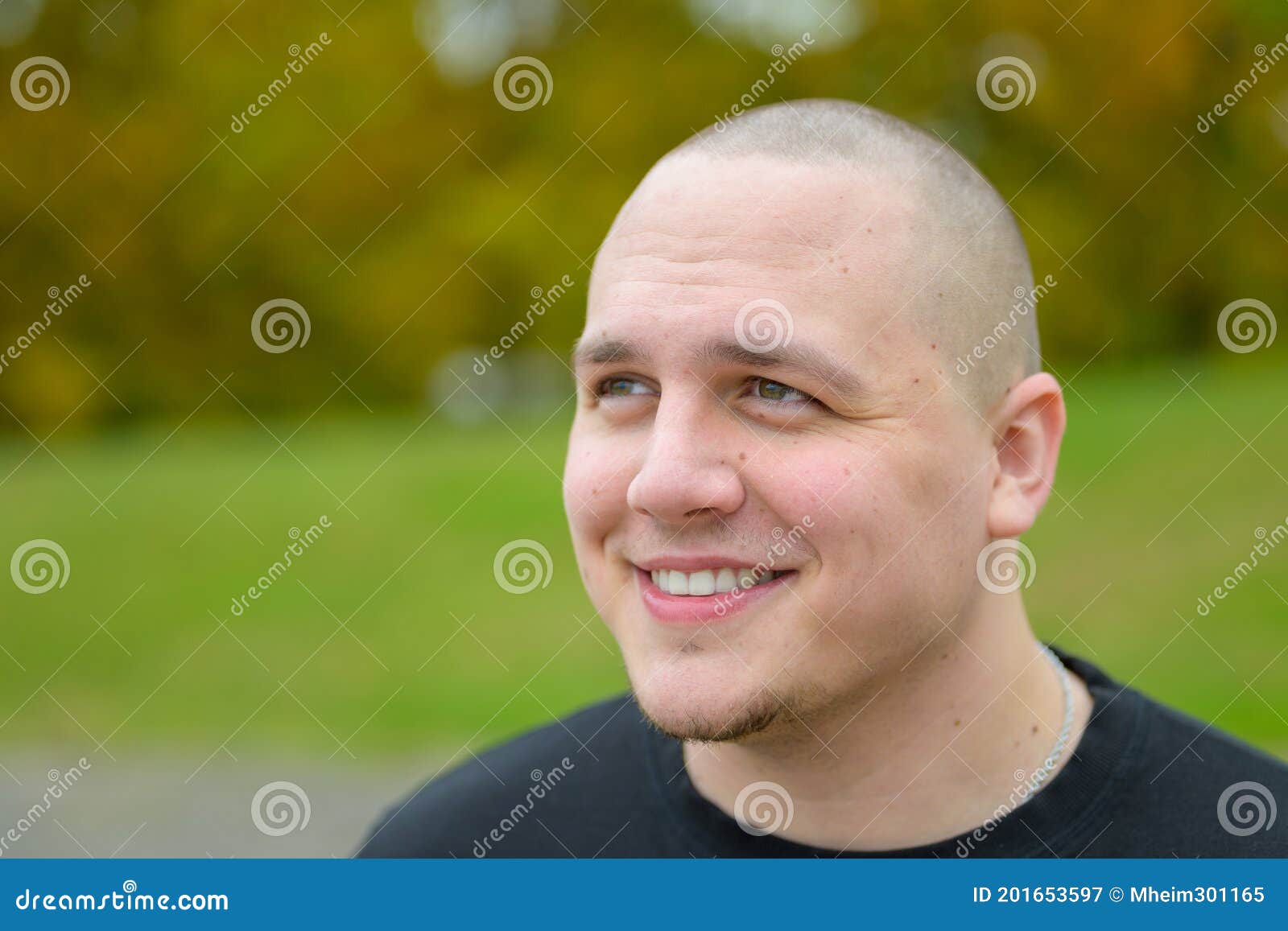 Young Man Looking Up with a Pleased Smile Stock Image - Image of shaved ...