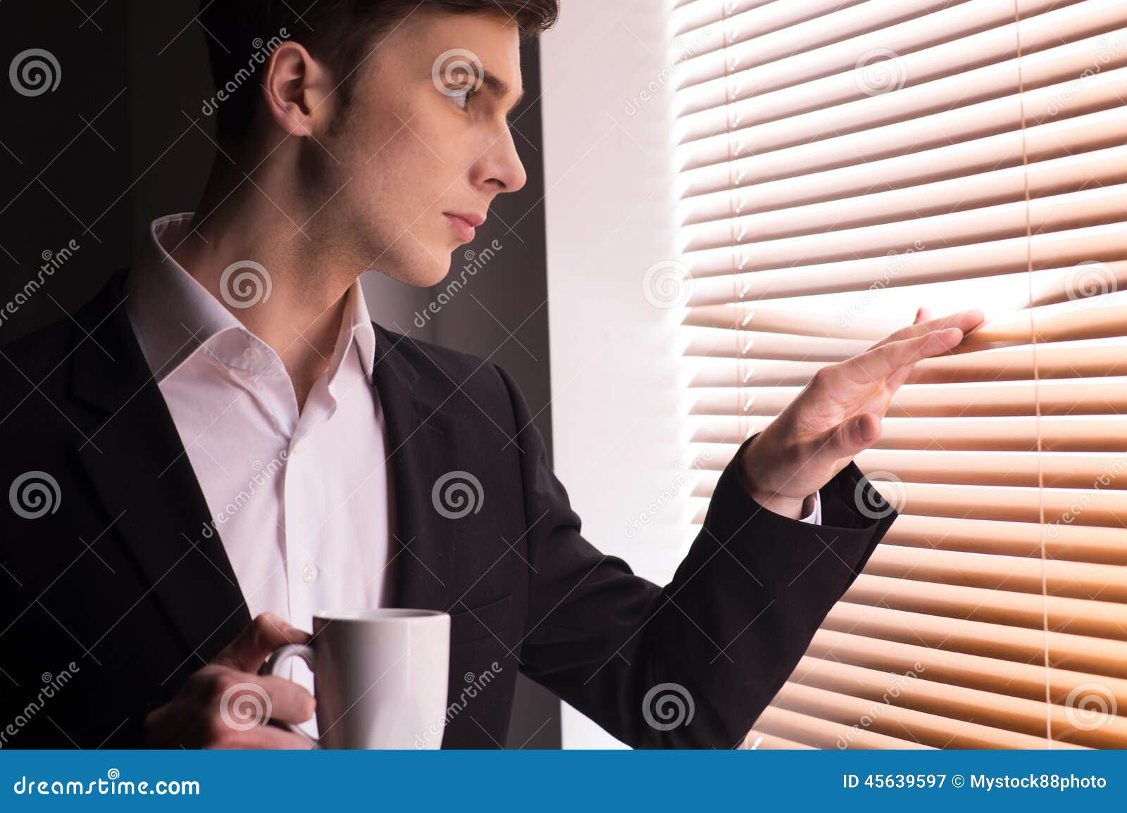 Young Man Looking through Window Blinds. Stock Image - Image of ...