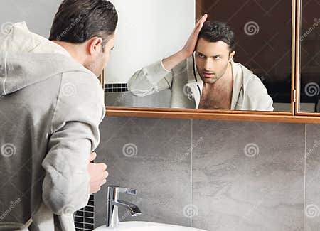 Man Looks at Himself in the Mirror Stock Photo - Image of conceited ...
