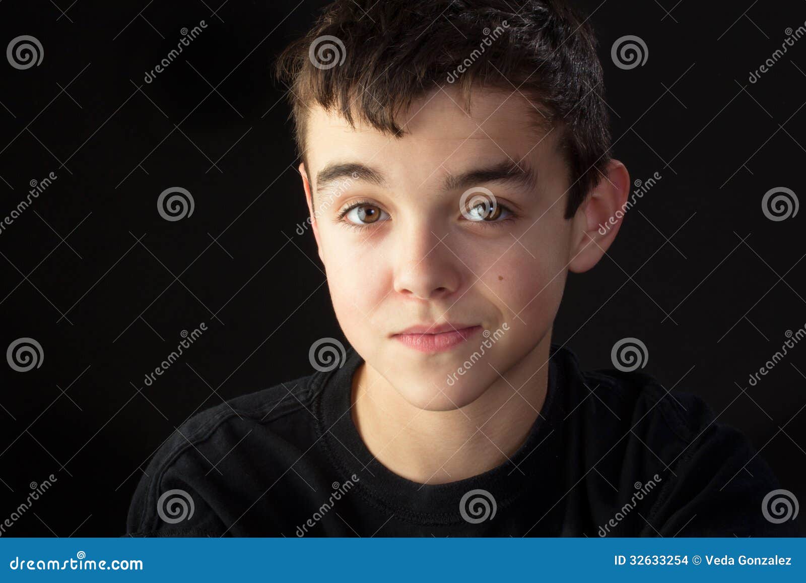 A Young Man Looks Slightly Amused Stock Photo - Image of eyes, hair ...