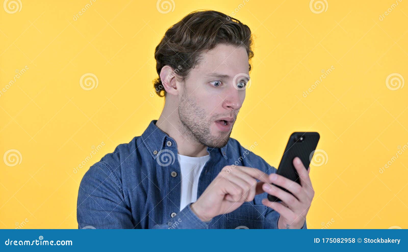 Young Man with Loss on Smartphone, Failure on Yellow Background Stock ...
