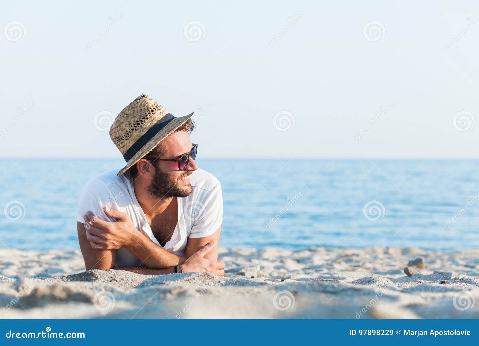 Young Man Lying on the Beach Stock Image - Image of happy, looking ...