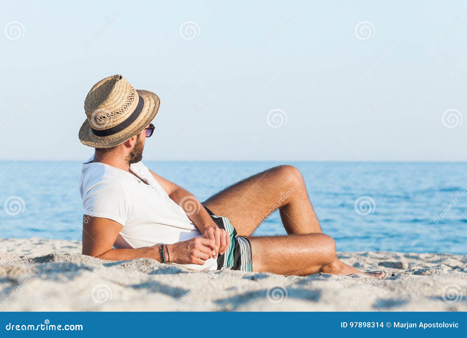 Young Man Lying on the Beach Stock Photo - Image of beautiful, portrait ...