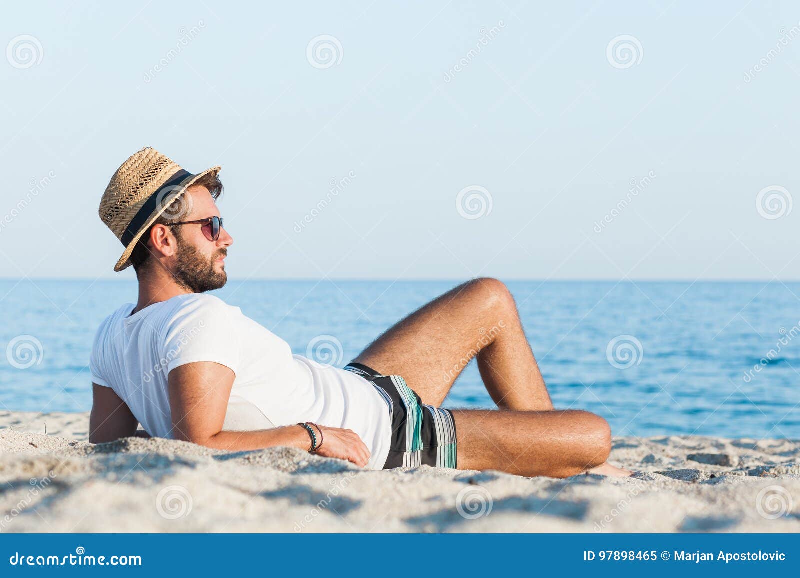 Young Man Lying on the Beach Stock Image - Image of looking, lifestyle ...