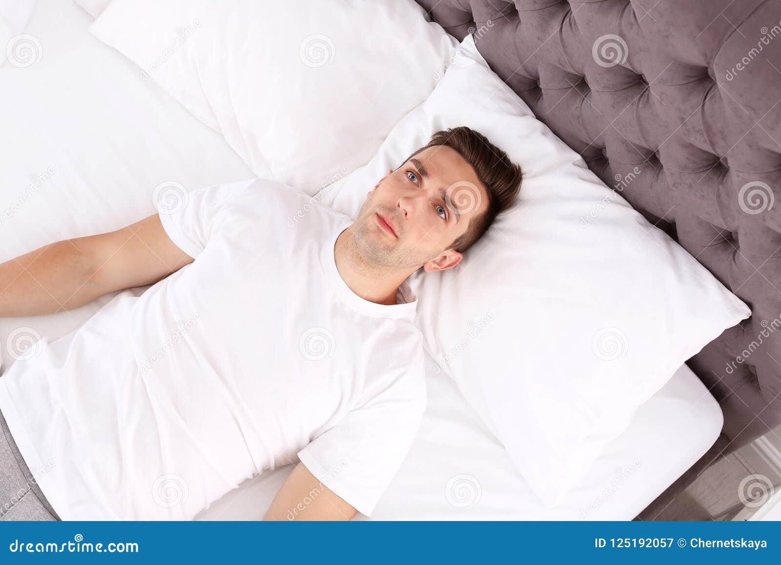 Young Man Lying in Bed at Home, Top View. Stock Image - Image of ...
