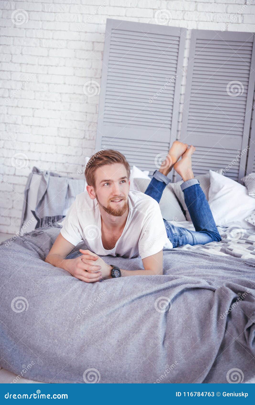 Young man lying in bed stock image. Image of peaceful - 116784763