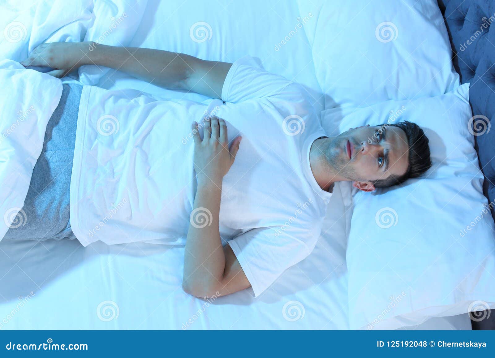 Young Man Lying in Bed at Night, Top View. Stock Photo - Image of rest ...