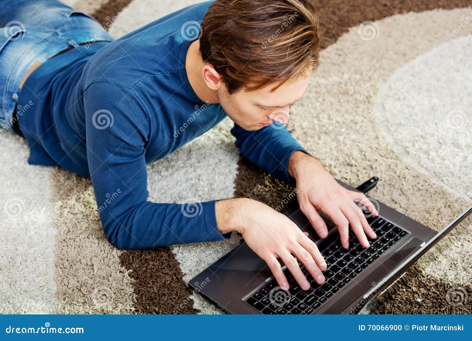 Young Man Lying on the Floor and Using Laptop Stock Photo - Image of ...