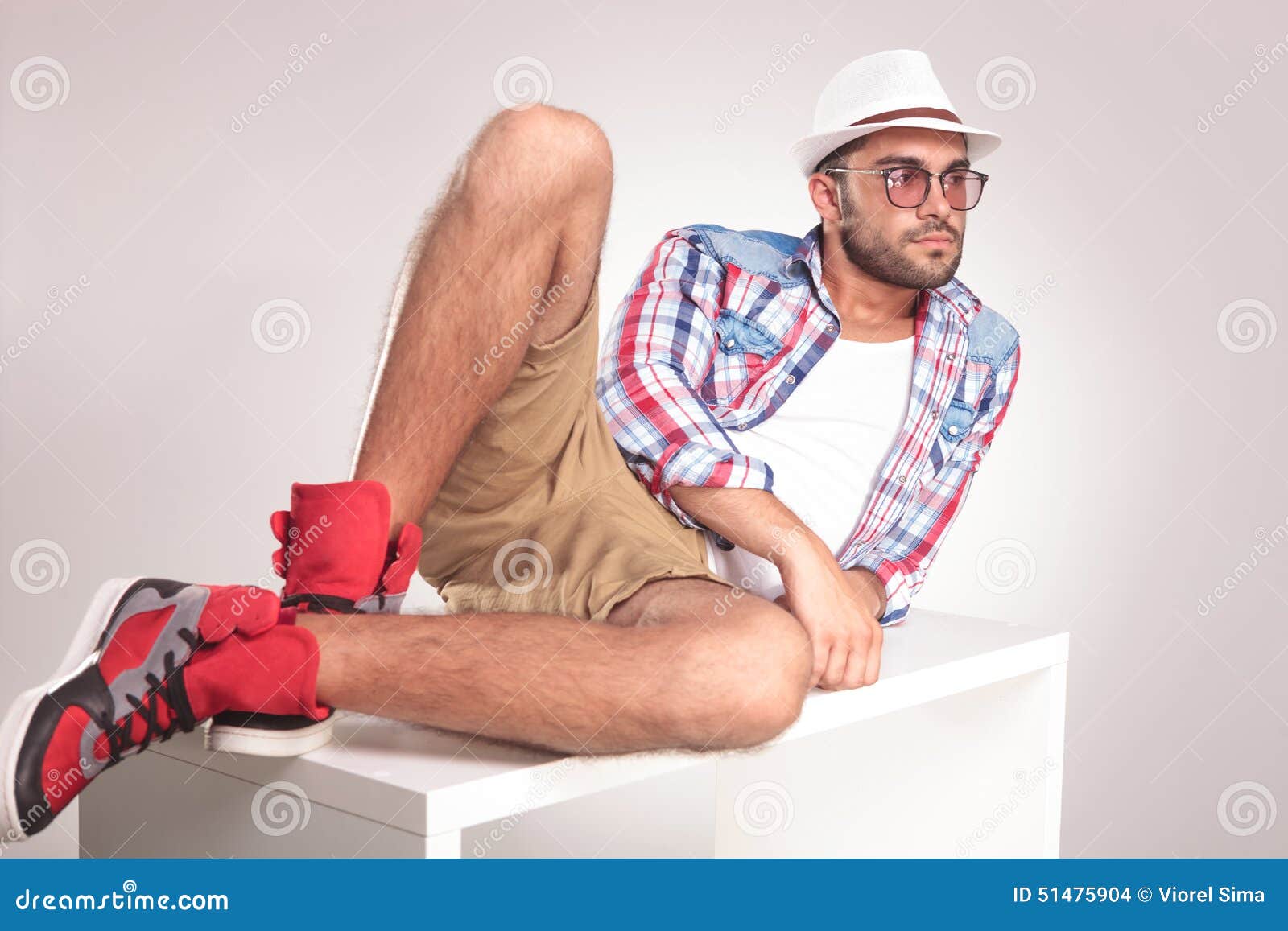 Young Man Lying on a White Table Stock Photo - Image of sunglasses ...