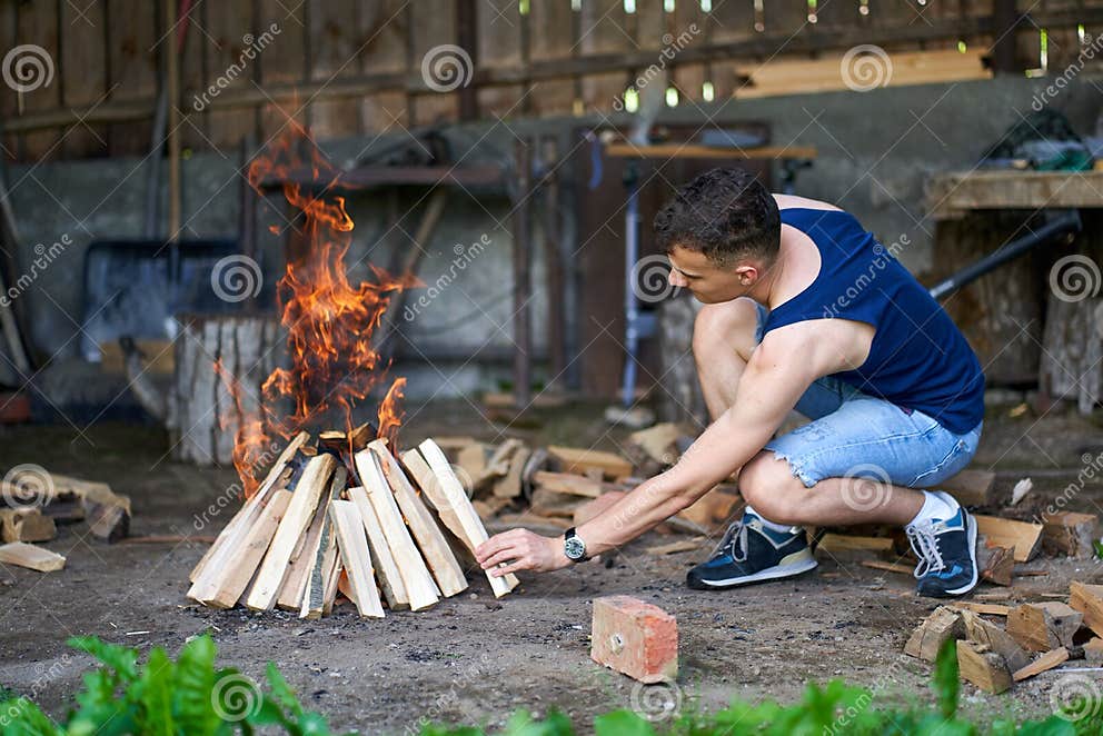 Young Man Making a Fire for Bbq Stock Image - Image of firewood, energy ...