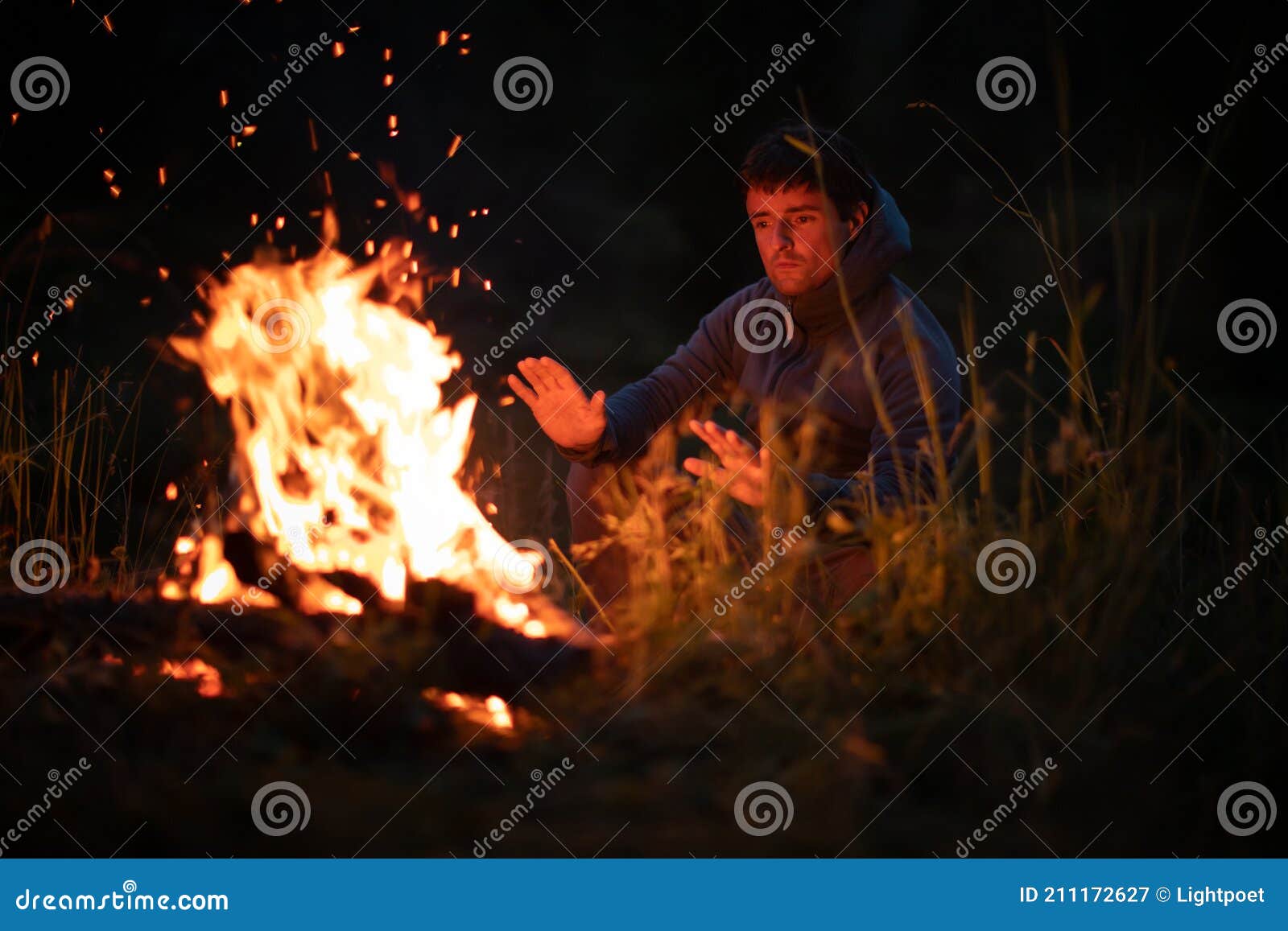 Young Man Making Fire while Camping Outdoors, Stock Image - Image of ...
