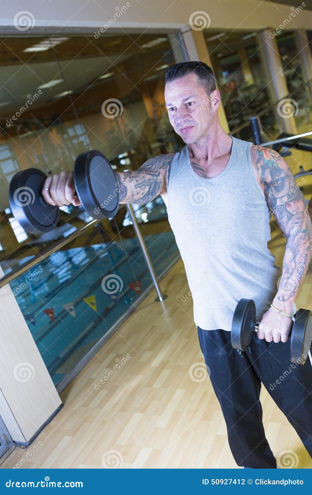 Young Man Making Front Raises - Workout Routine Stock Photo - Image of ...