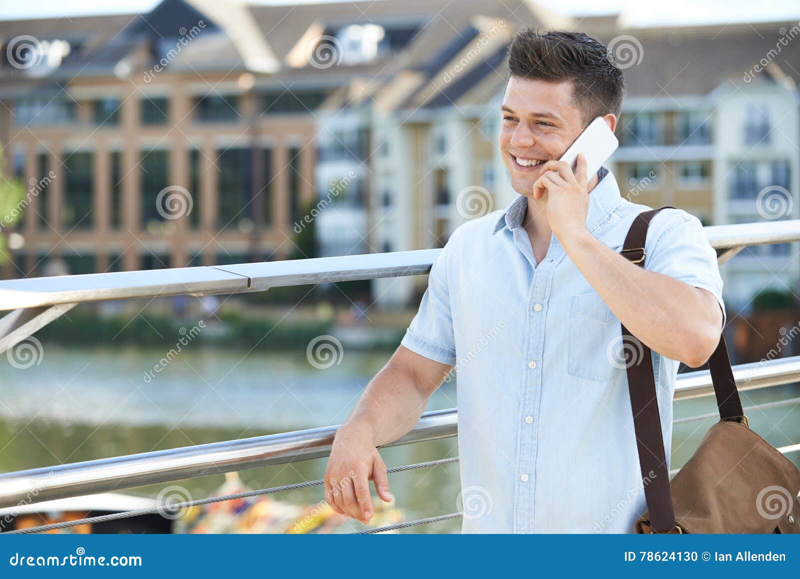 Young Man Making Phone Call on Mobile Phone Walking To Work Stock Photo ...
