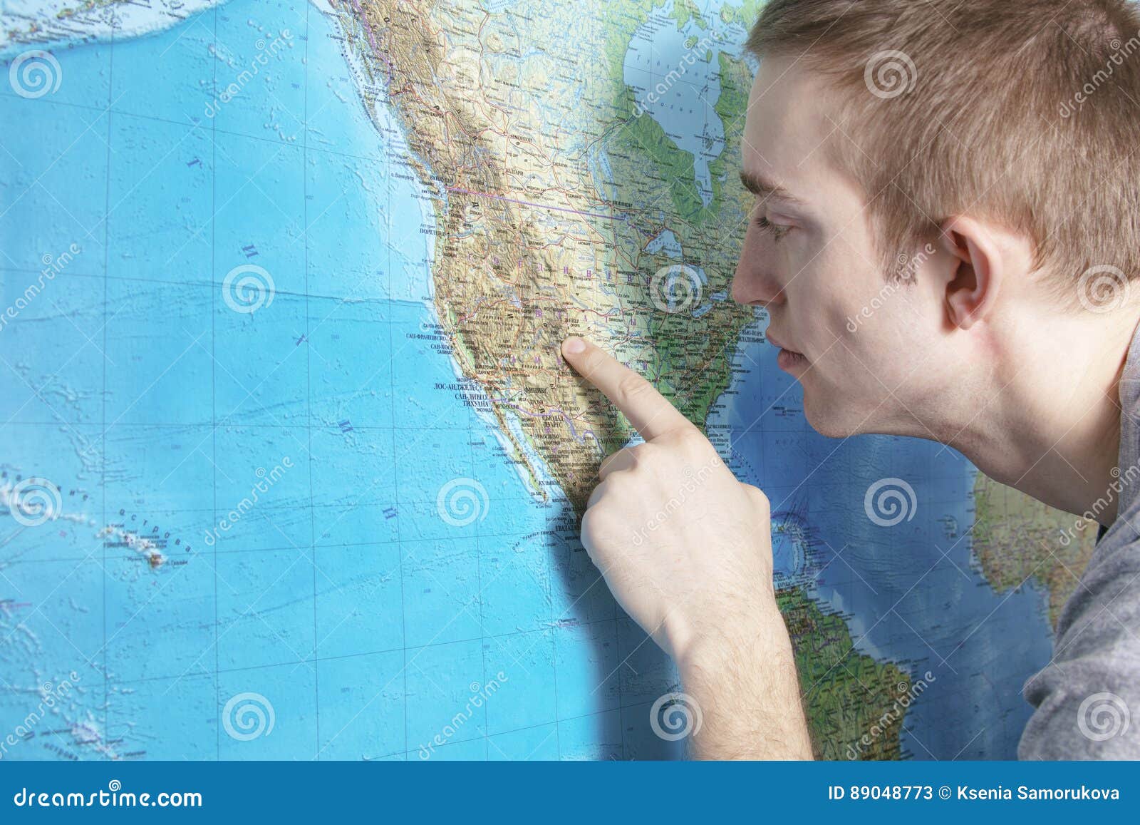 A young man at the map stock image. Image of background - 89048773