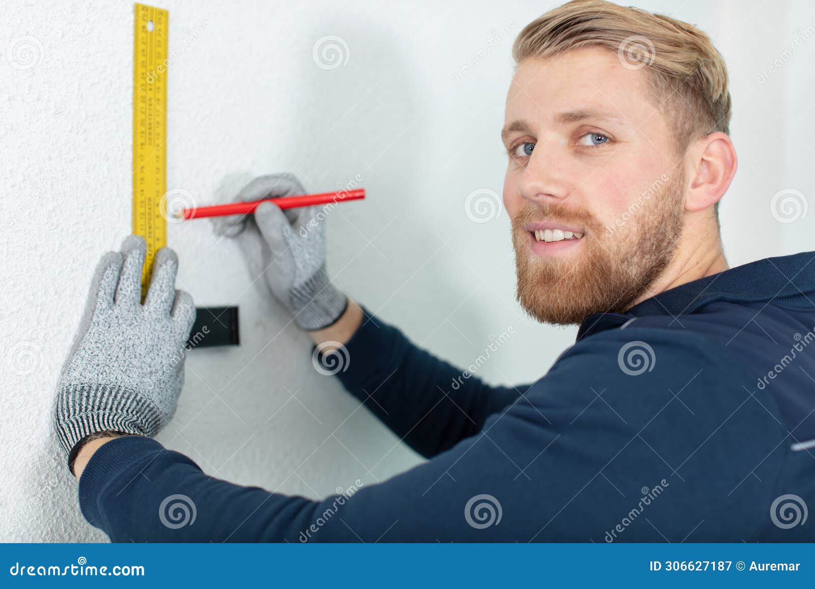 Young Man Marking Wall at Construction Site Stock Image - Image of ...