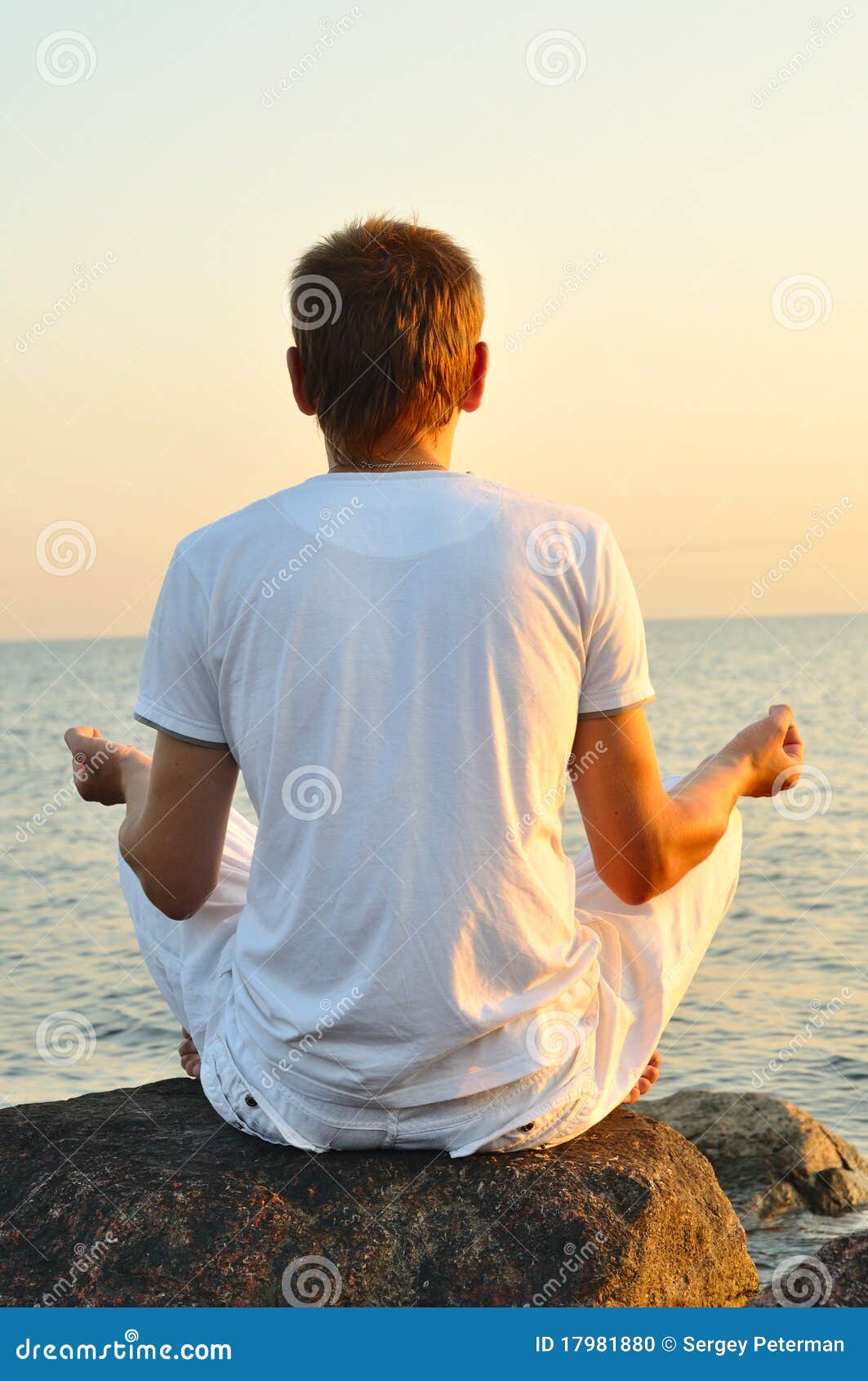 Young man is meditating stock photo. Image of freedom - 17981880